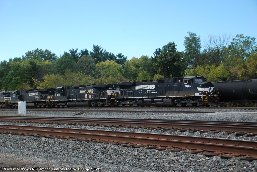 NS 9640 leads a train east.
